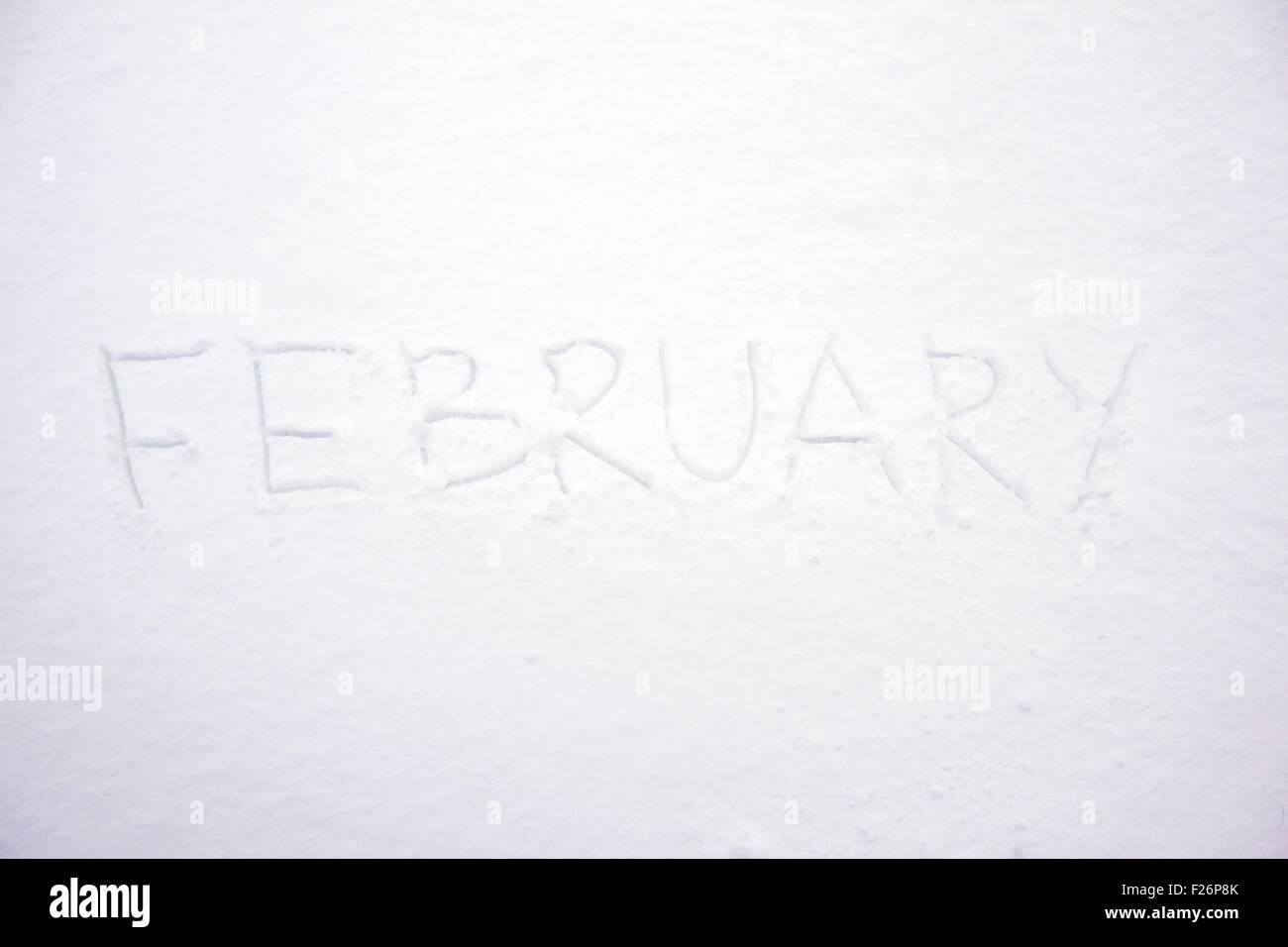 February month hand written text on snow Stock Photo - Alamy