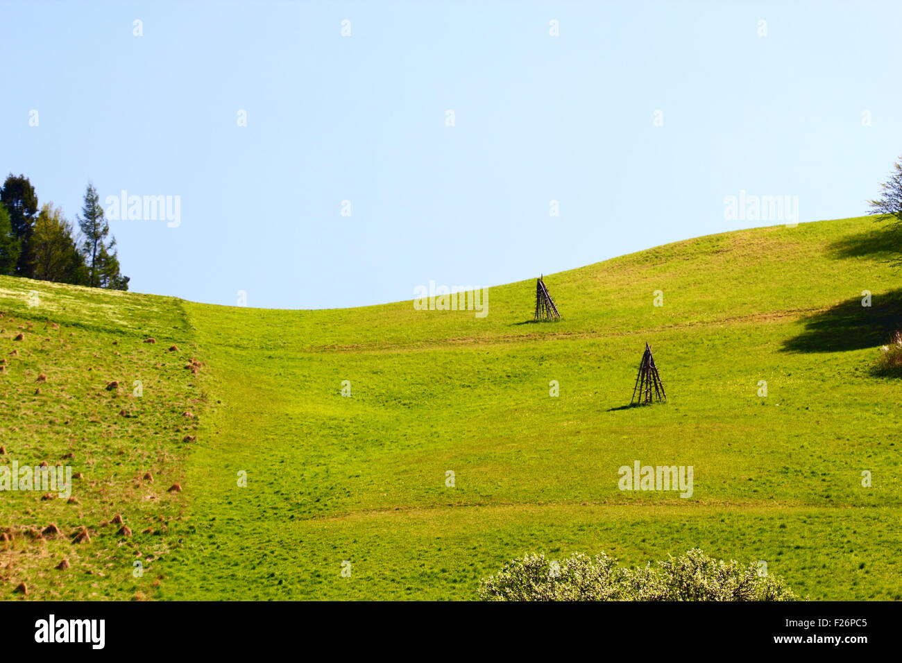 Spring. Green hill and sky background Stock Photo - Alamy