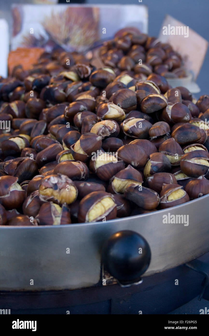 Freshly roasted chestnuts inside a iron plate Stock Photo - Alamy