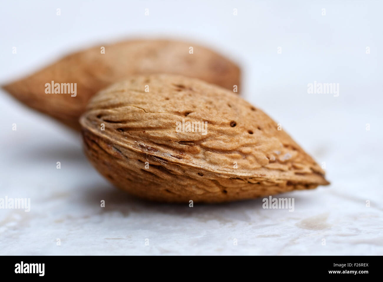 Photo of two almonds on marble surface Stock Photo - Alamy
