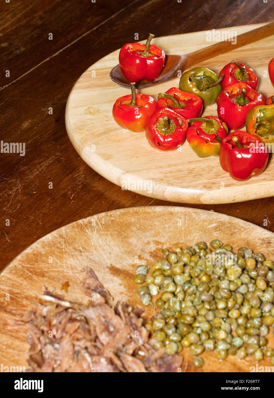 Red hot chili peppers on cutting board, capers and anchovies Stock ...