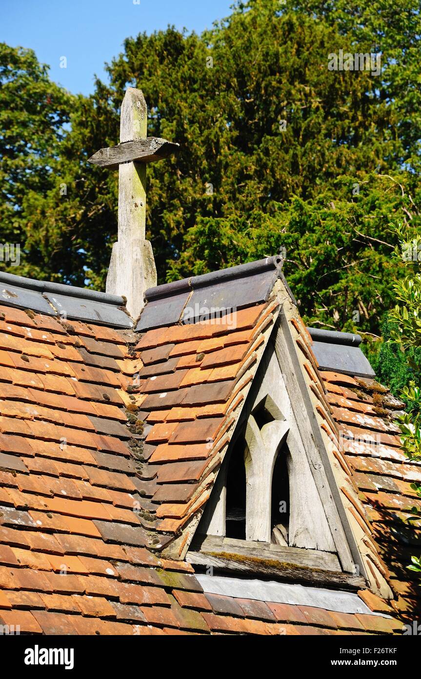 Dormer window and stone cross on the roof of the gatehouse to the ...