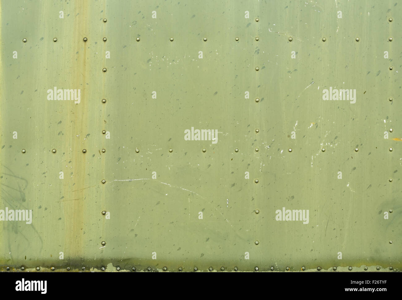 Abstract painted matte green metal background with rivets. Riveted ...
