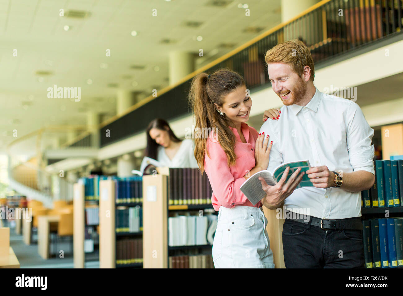 Young couple in the library Stock Photo - Alamy