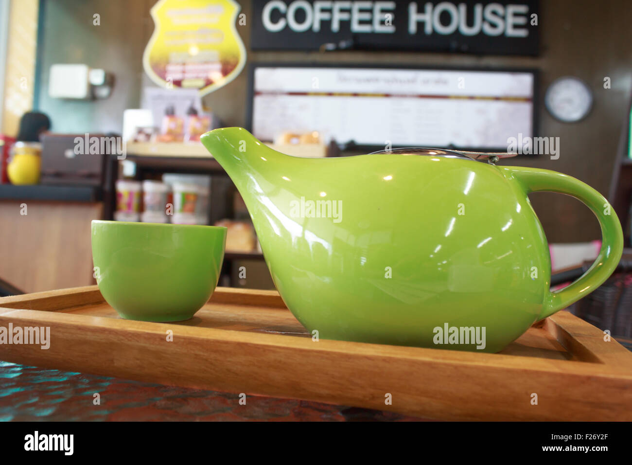 Green teapot and teacup in a cafe Stock Photo - Alamy