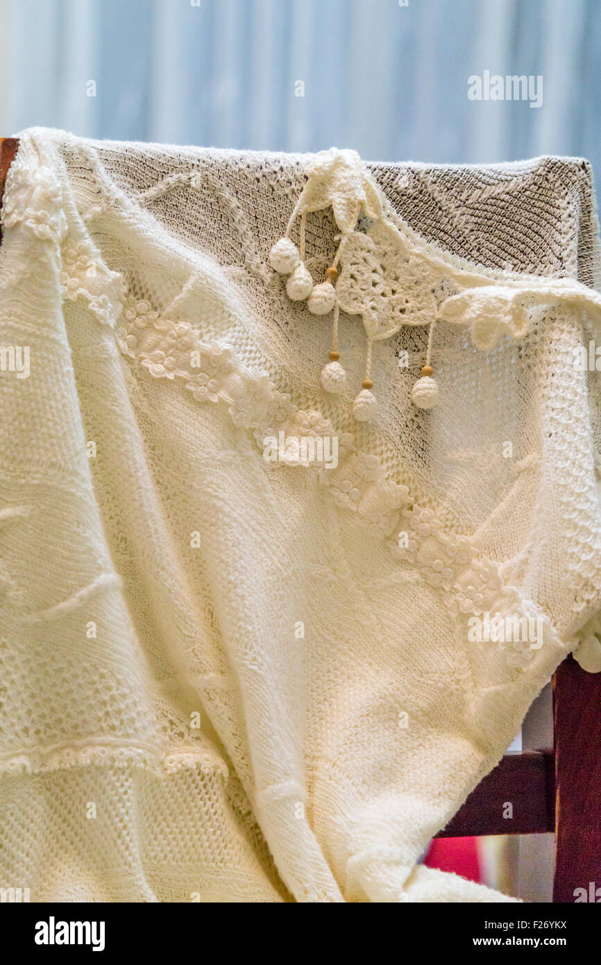 Long white dress draped over brown chair Stock Photo - Alamy