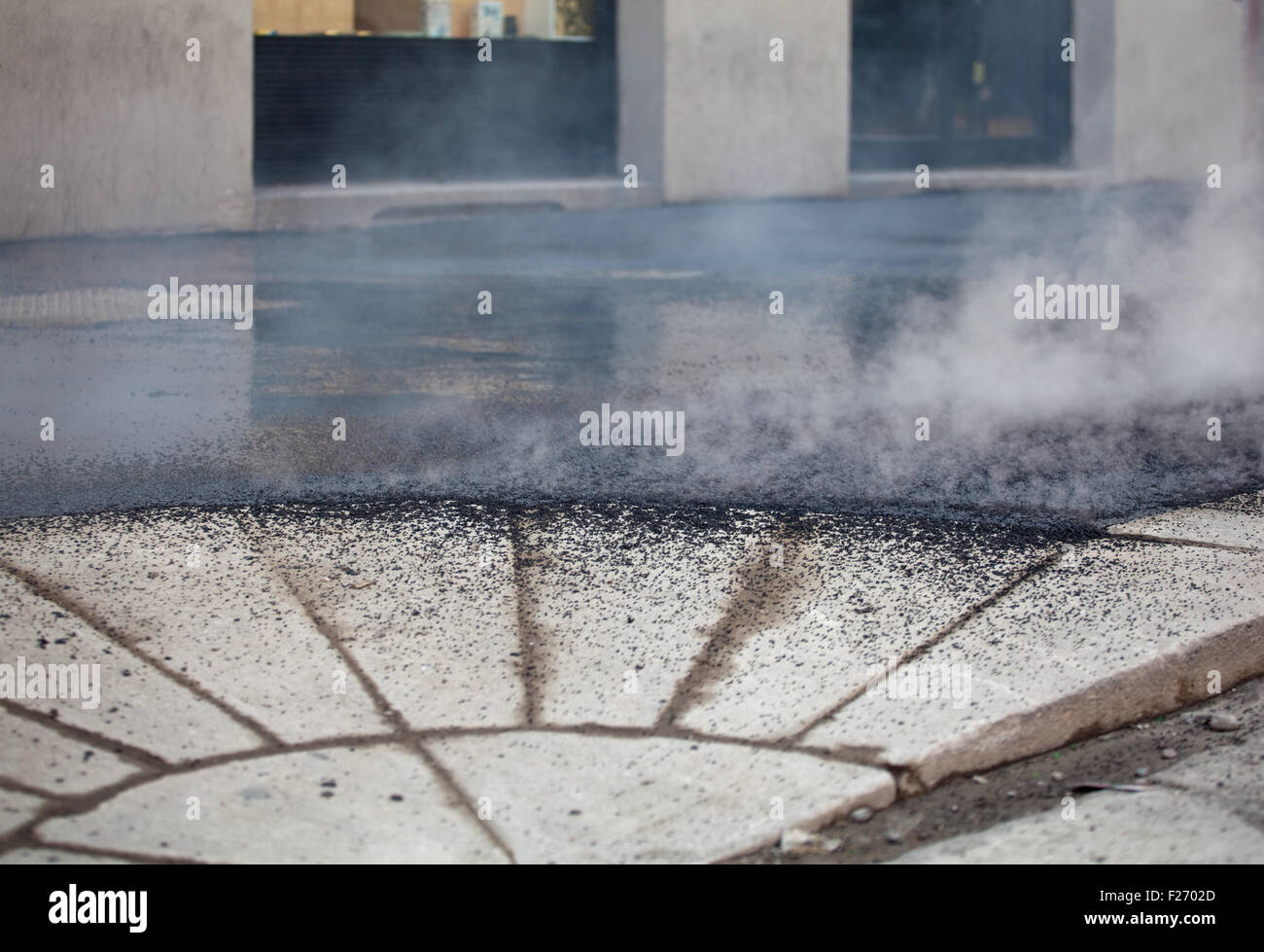 Photo of new Asphalt smoking Stock Photo - Alamy