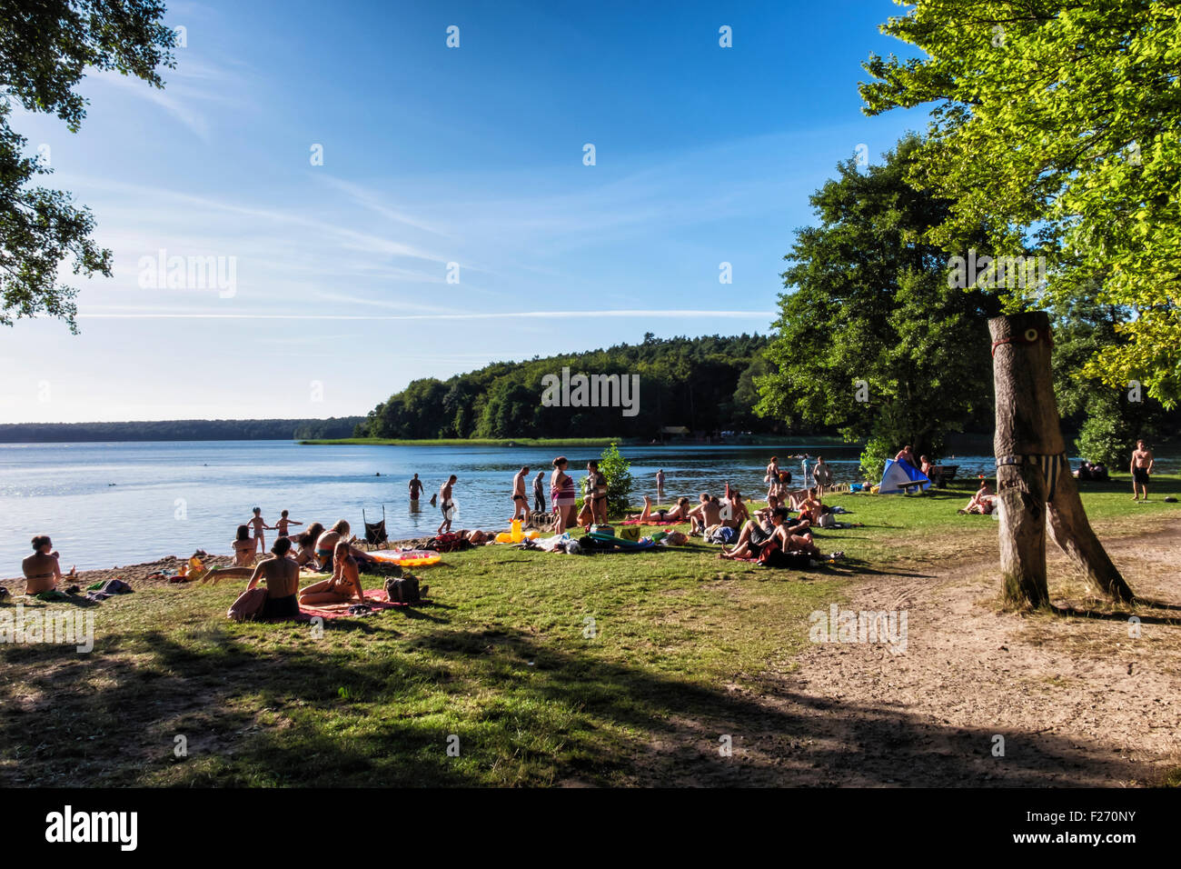 Blue lake, trees, swimmers, sunbathers and open water swimming at ...