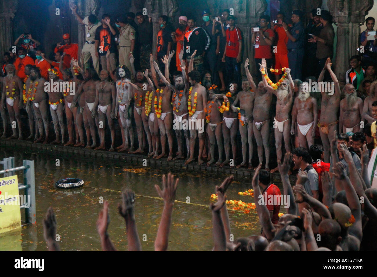 Naga Sadhus preparing to take a dip in a holy pond during the second ...