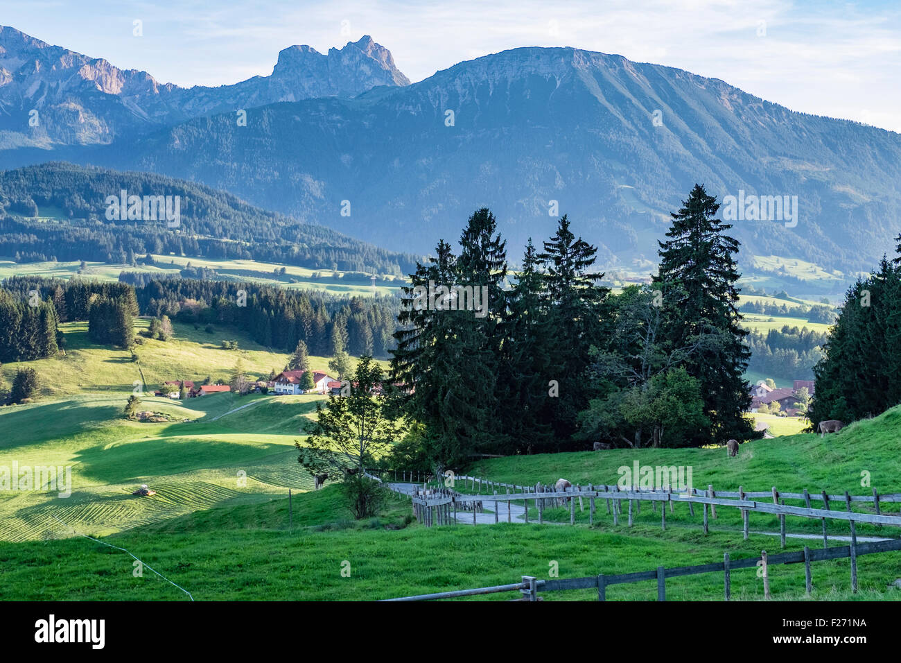 Bavarian Alps, landscape view of farm land, trees, mountains and sky ...