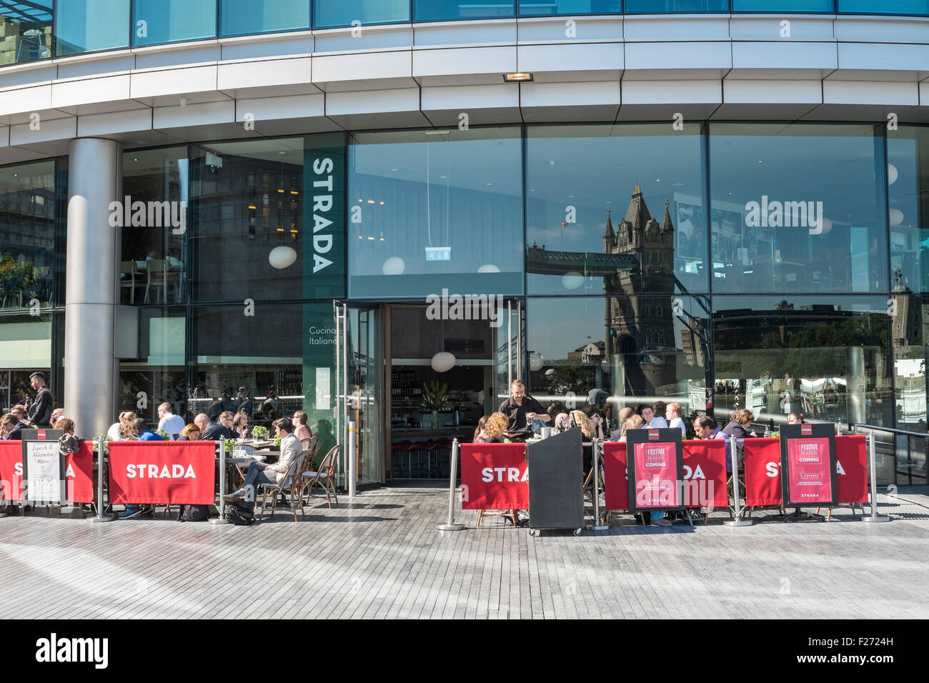 DIners sitting outside in sunshine at Strada restaurant, More London ...