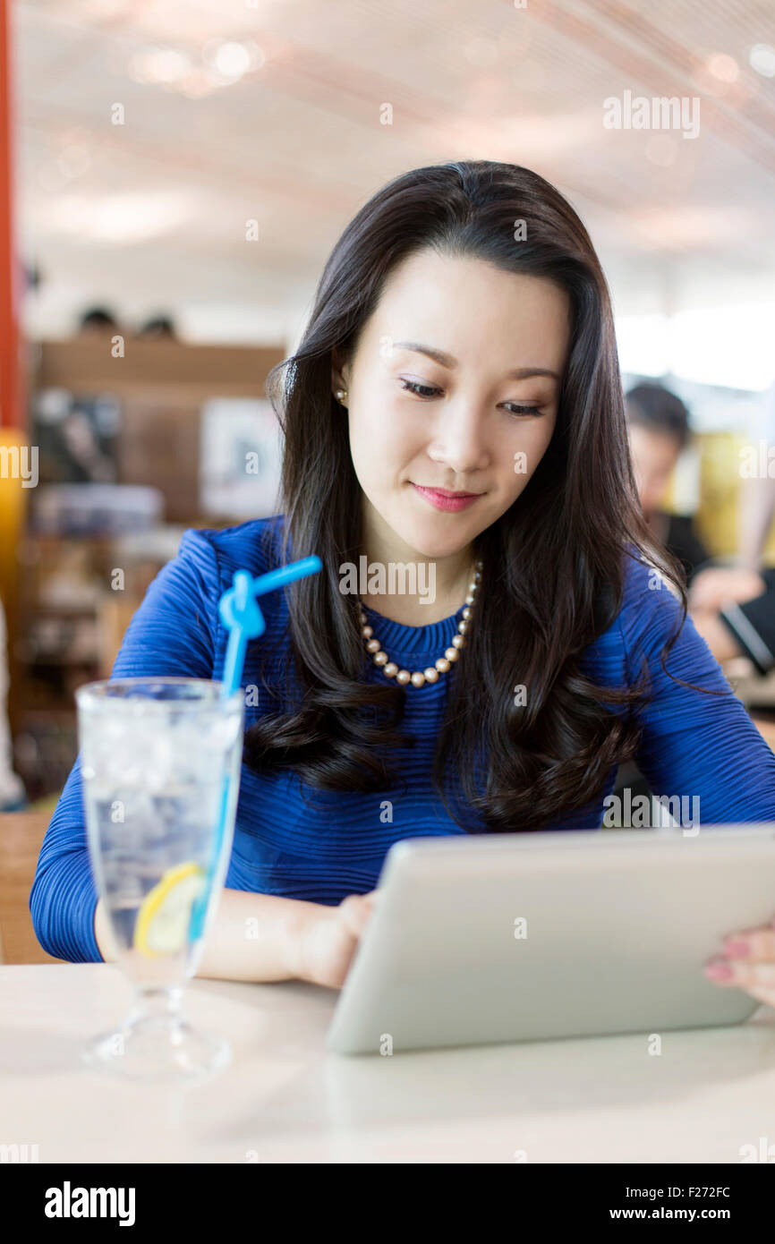 wowan using digital tablet at the airport Stock Photo - Alamy
