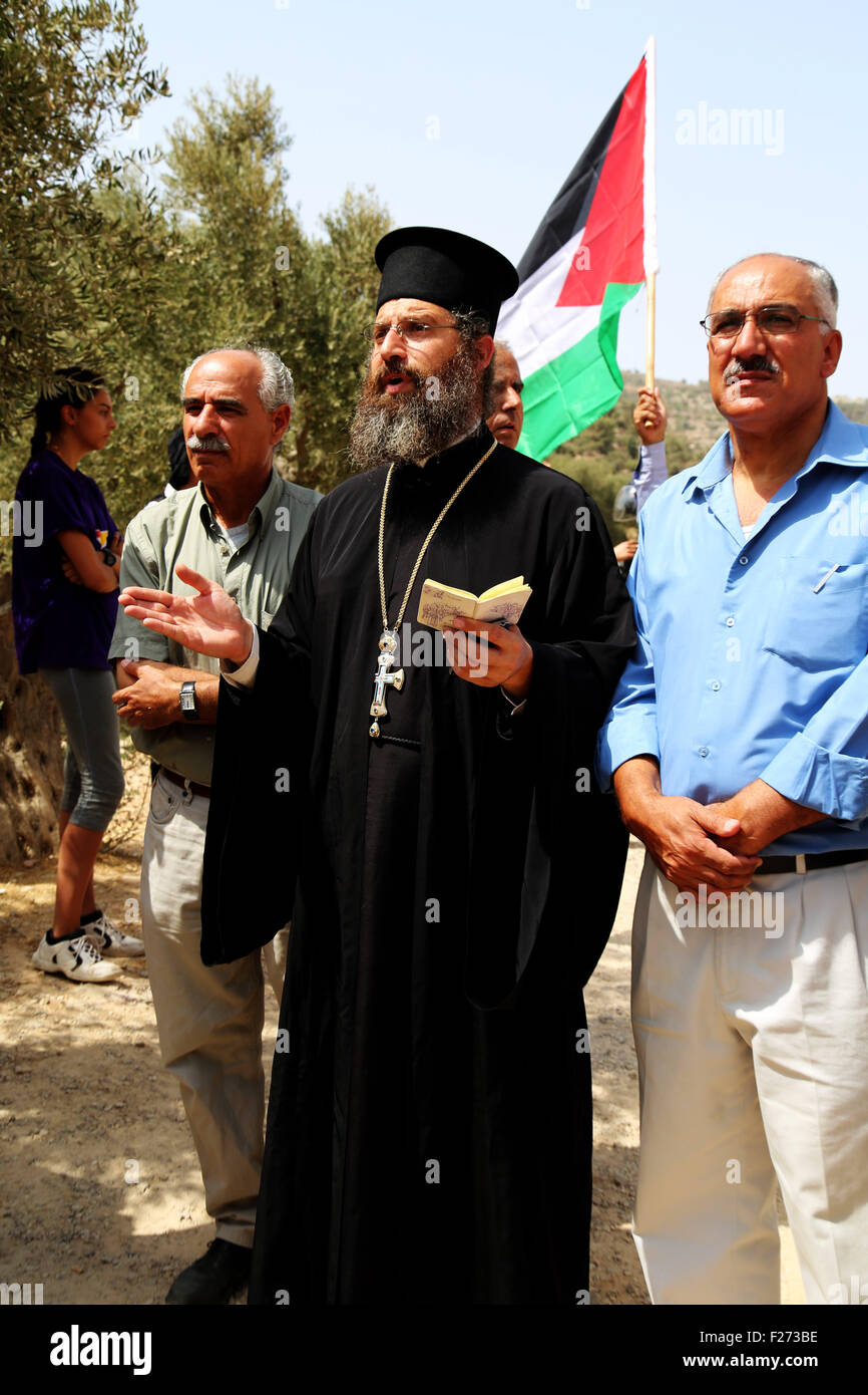 An Eastern Orthodox priest prays with fellow Palestinian Christians in ...