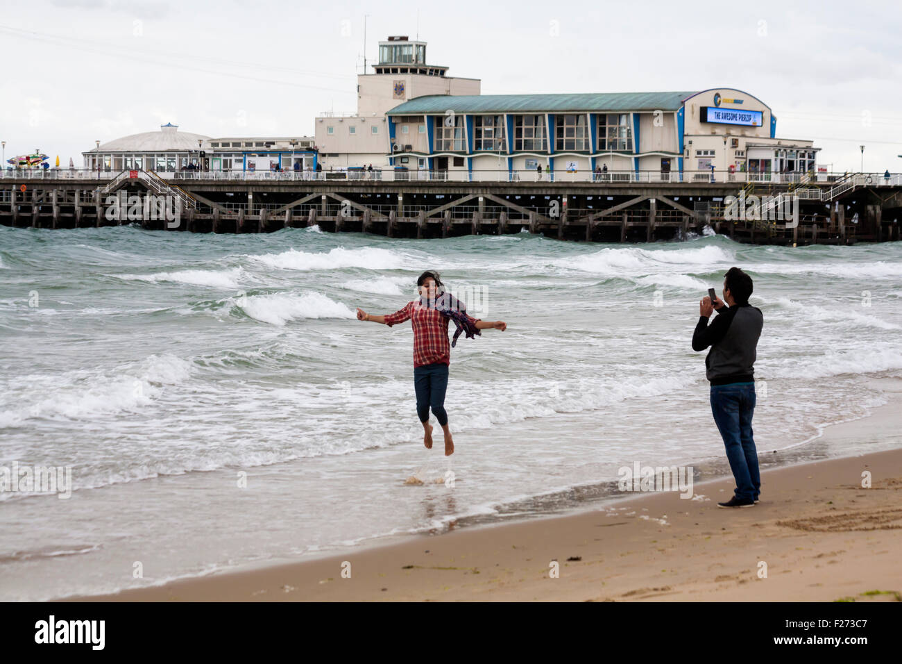 Bournemouth, Dorset, UK 13 September 2015. Young woman jumping in the ...