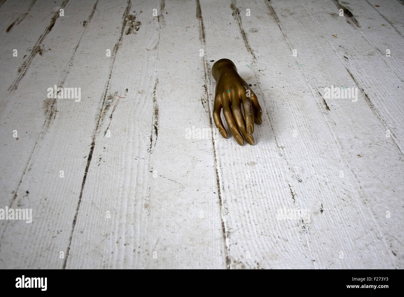 Hand gilded on the wooden white floor Stock Photo - Alamy