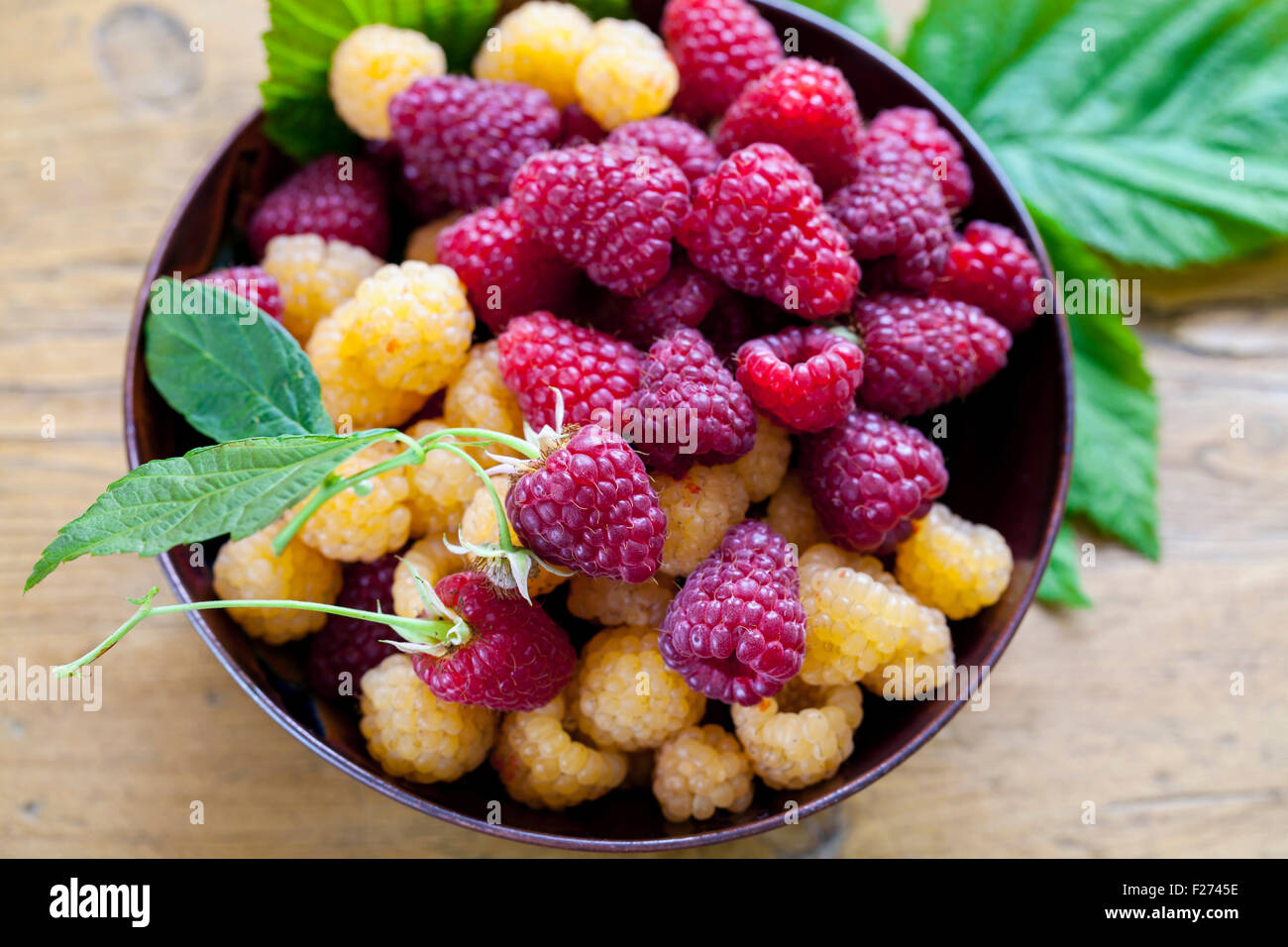 Yellow and red raspberries Stock Photo - Alamy