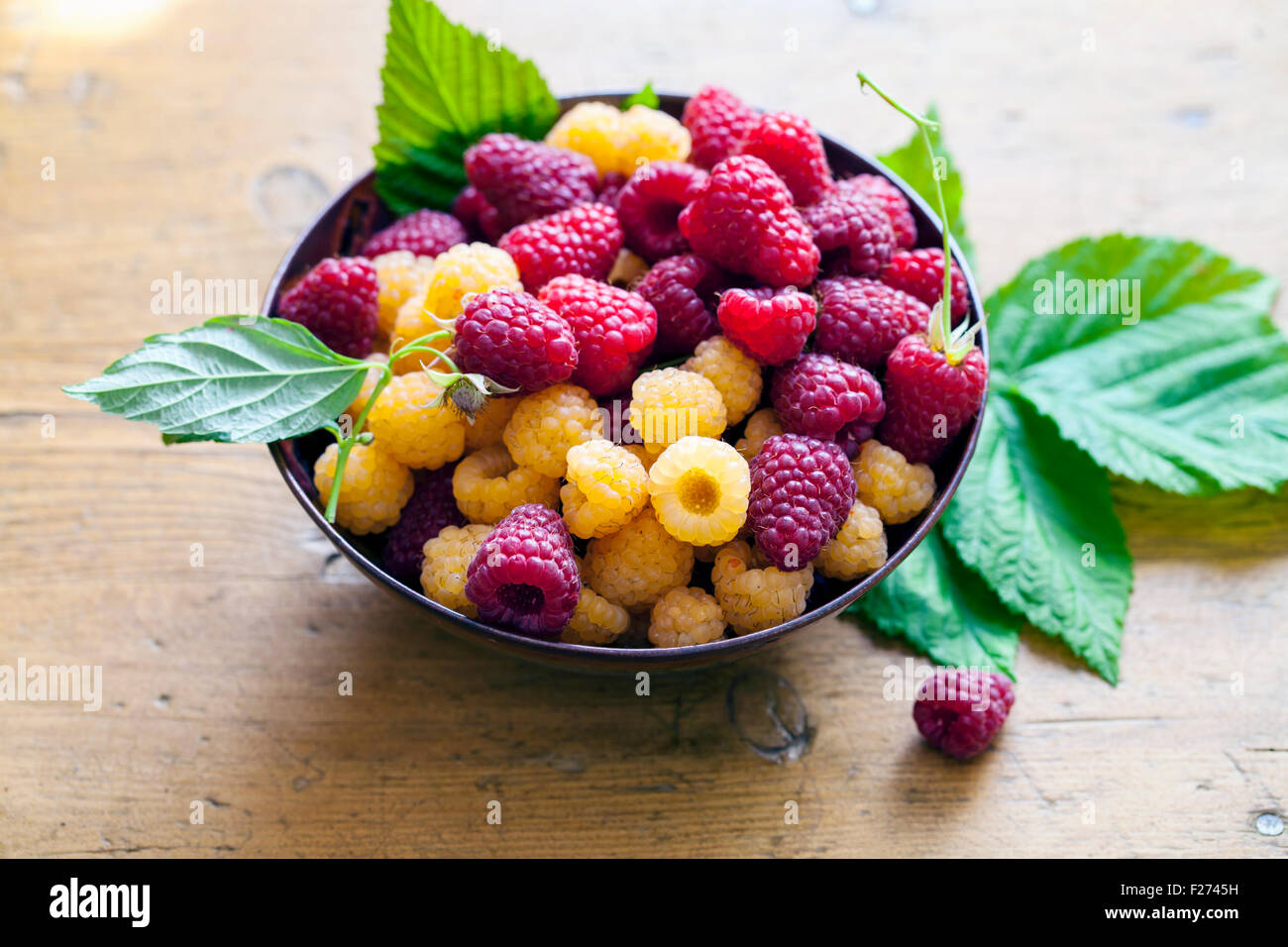 Yellow and red raspberries Stock Photo - Alamy