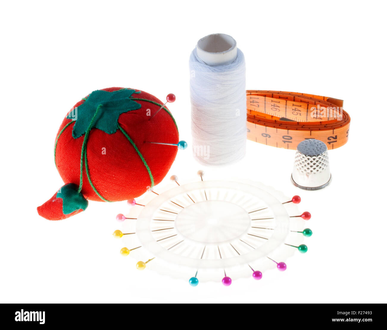 Pincushion, needle, cotton thread and tape Stock Photo - Alamy