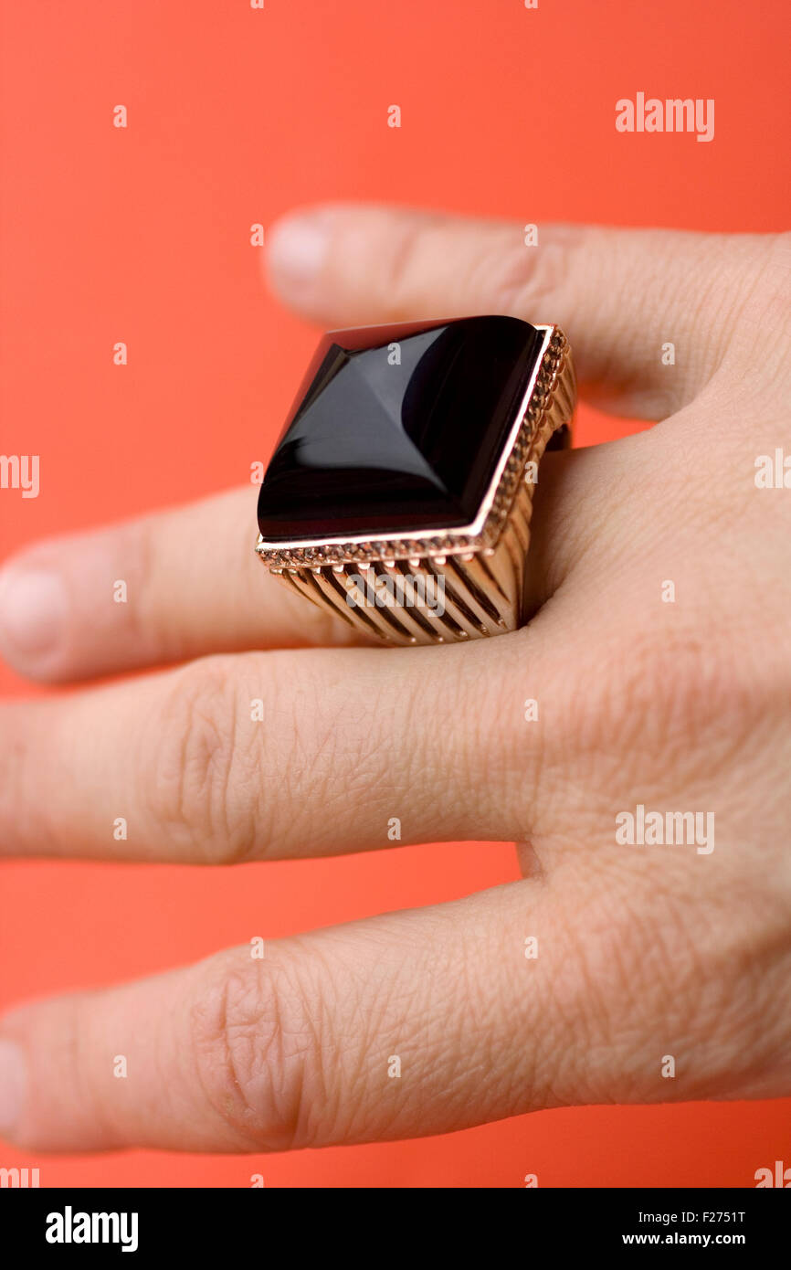 Ring with obsidian on red background Stock Photo - Alamy