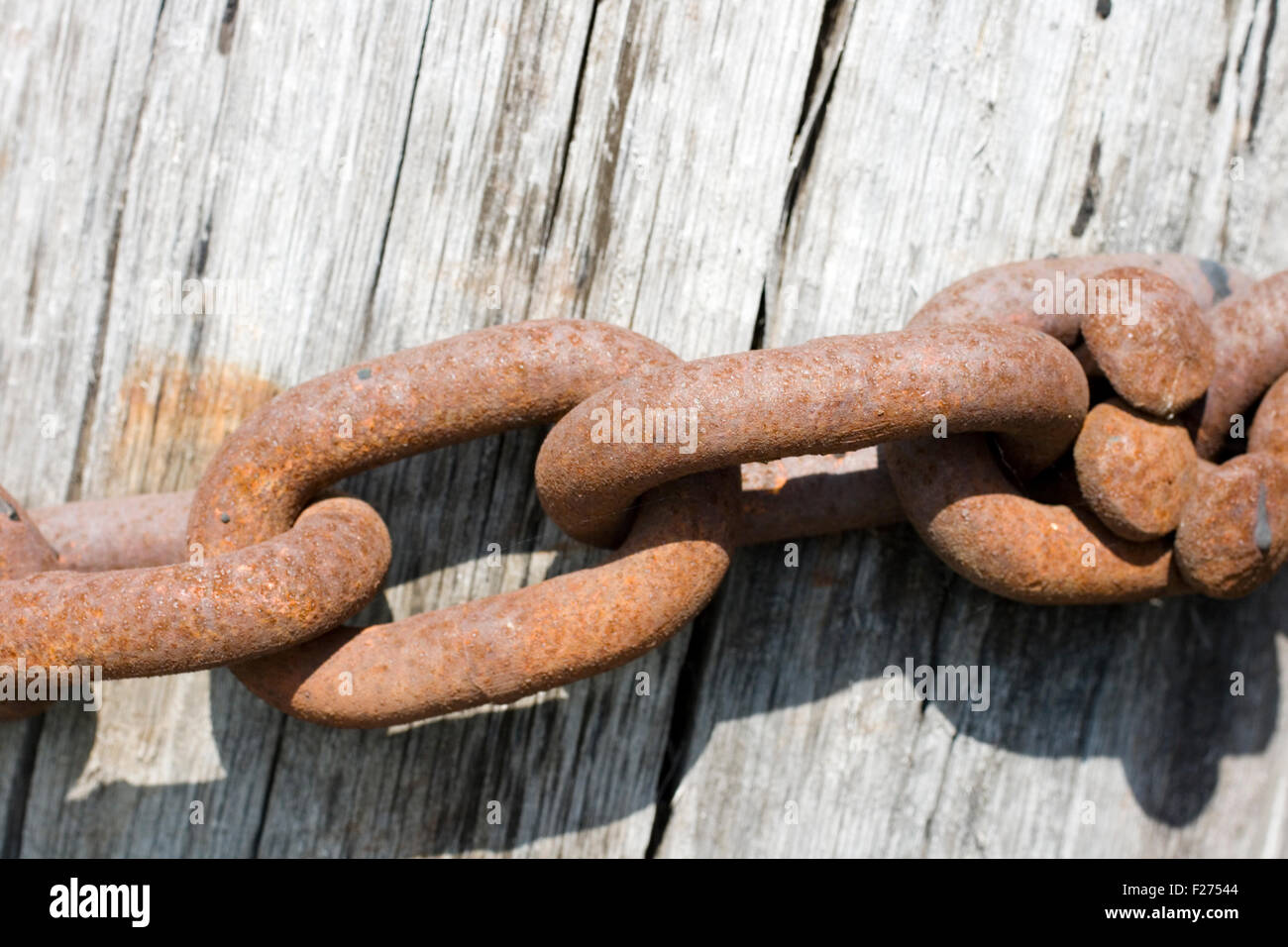 Rusty chain tied to the seapole Stock Photo - Alamy