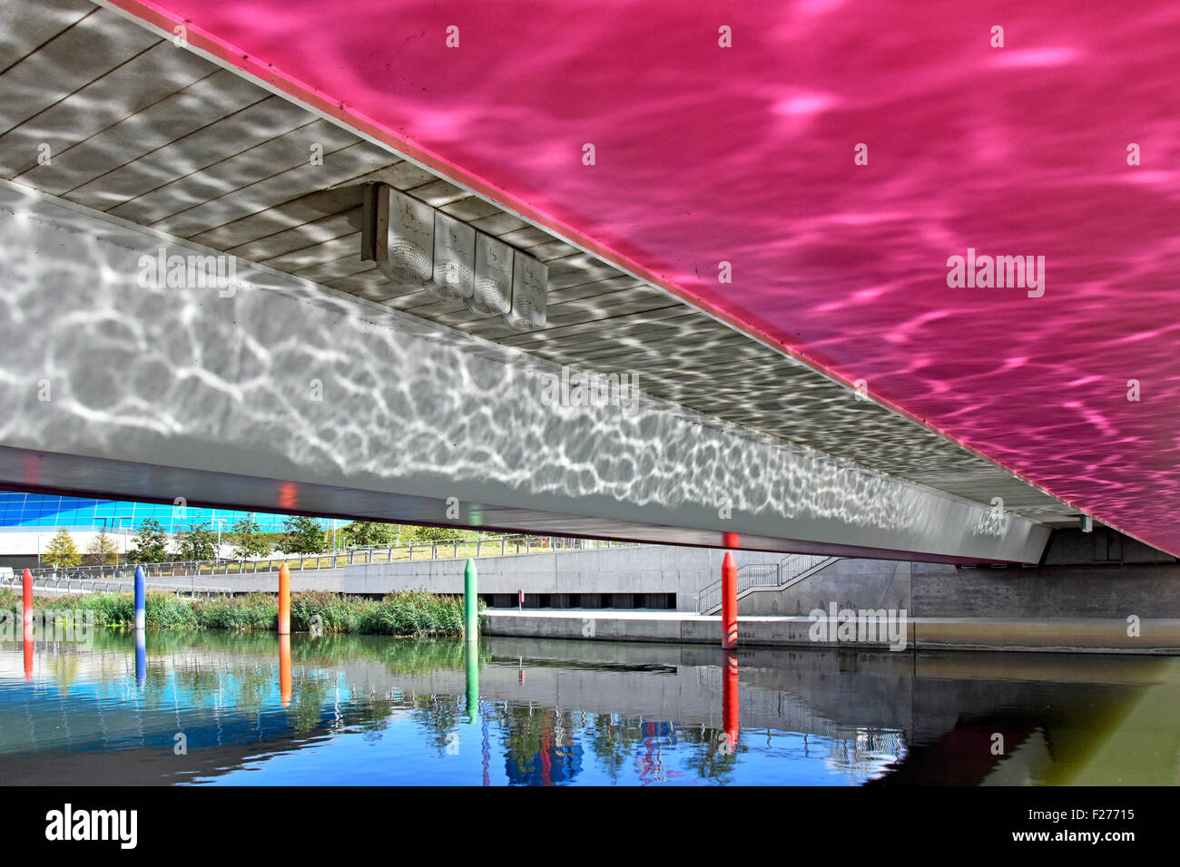 Reflection water abstract patterns from coloured underside of bridge in ...