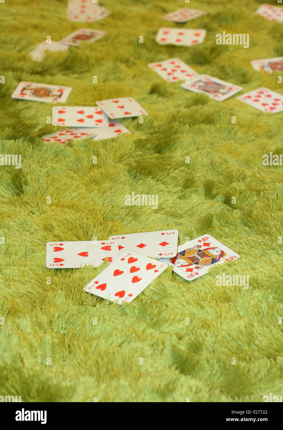 Poker cards on green carpet Stock Photo - Alamy