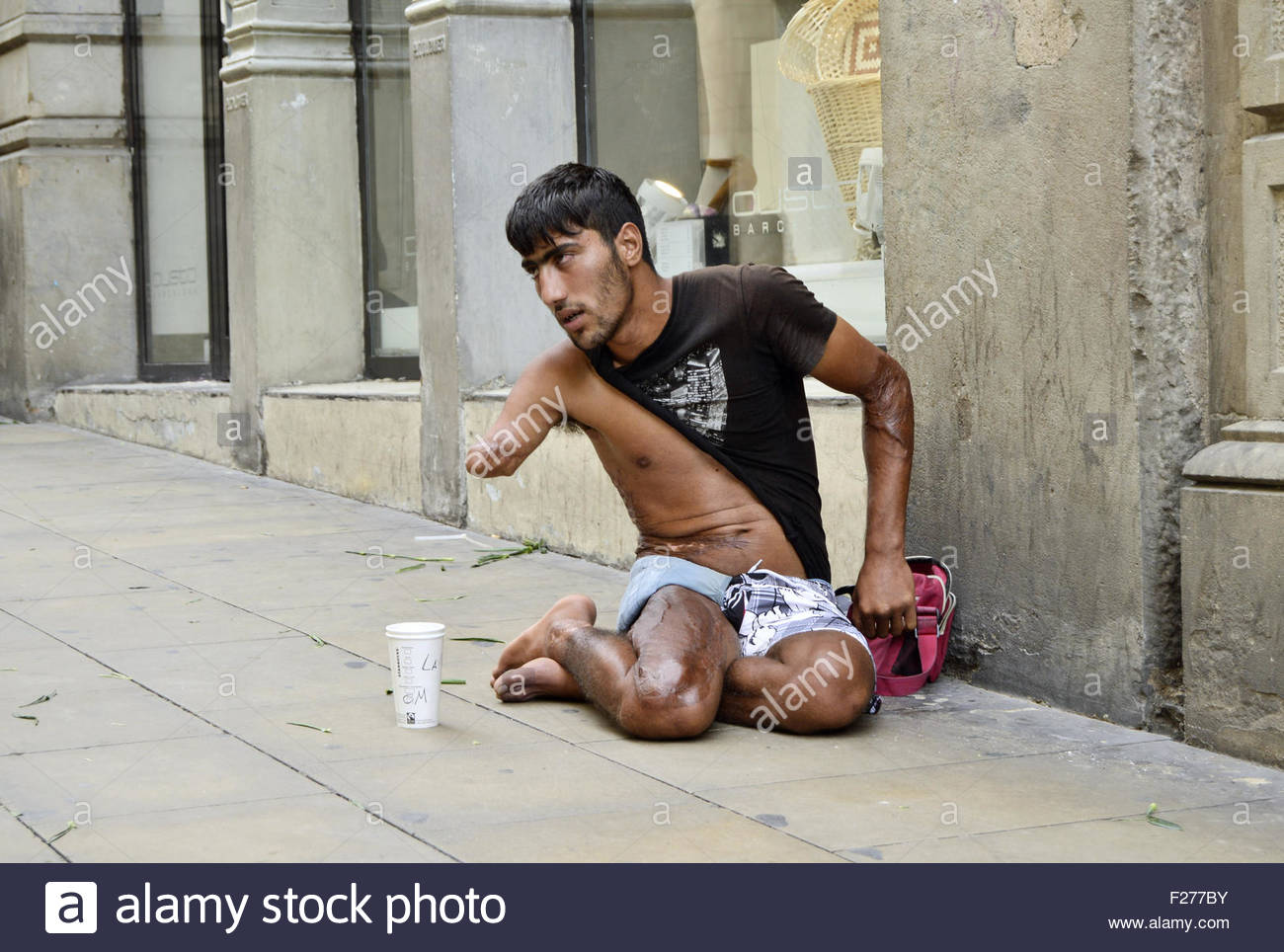 Disabled armless man begging for money in the street of Barri Gotic ...