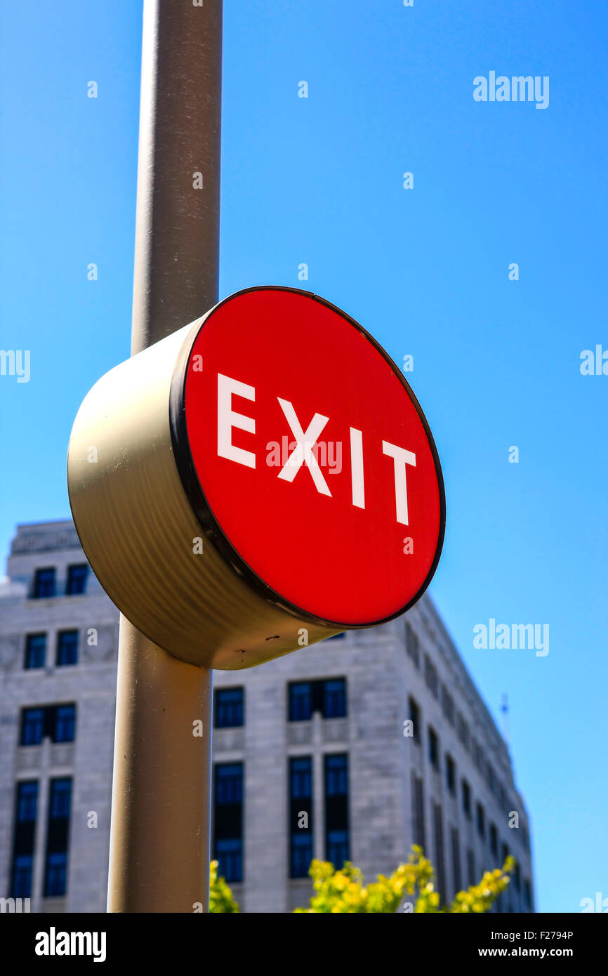 Round barrel shaped Exit sign in red and white Stock Photo - Alamy