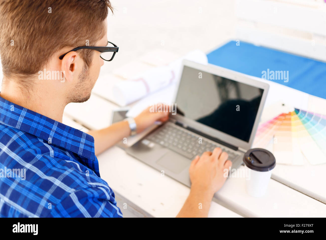Positive freelancer working on the notebook Stock Photo - Alamy