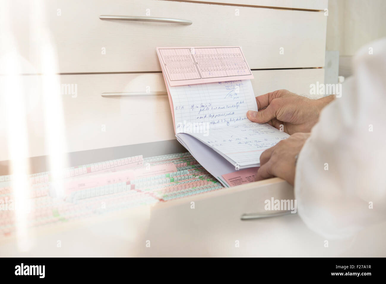 Male doctor reading medical chart hi-res stock photography and images ...