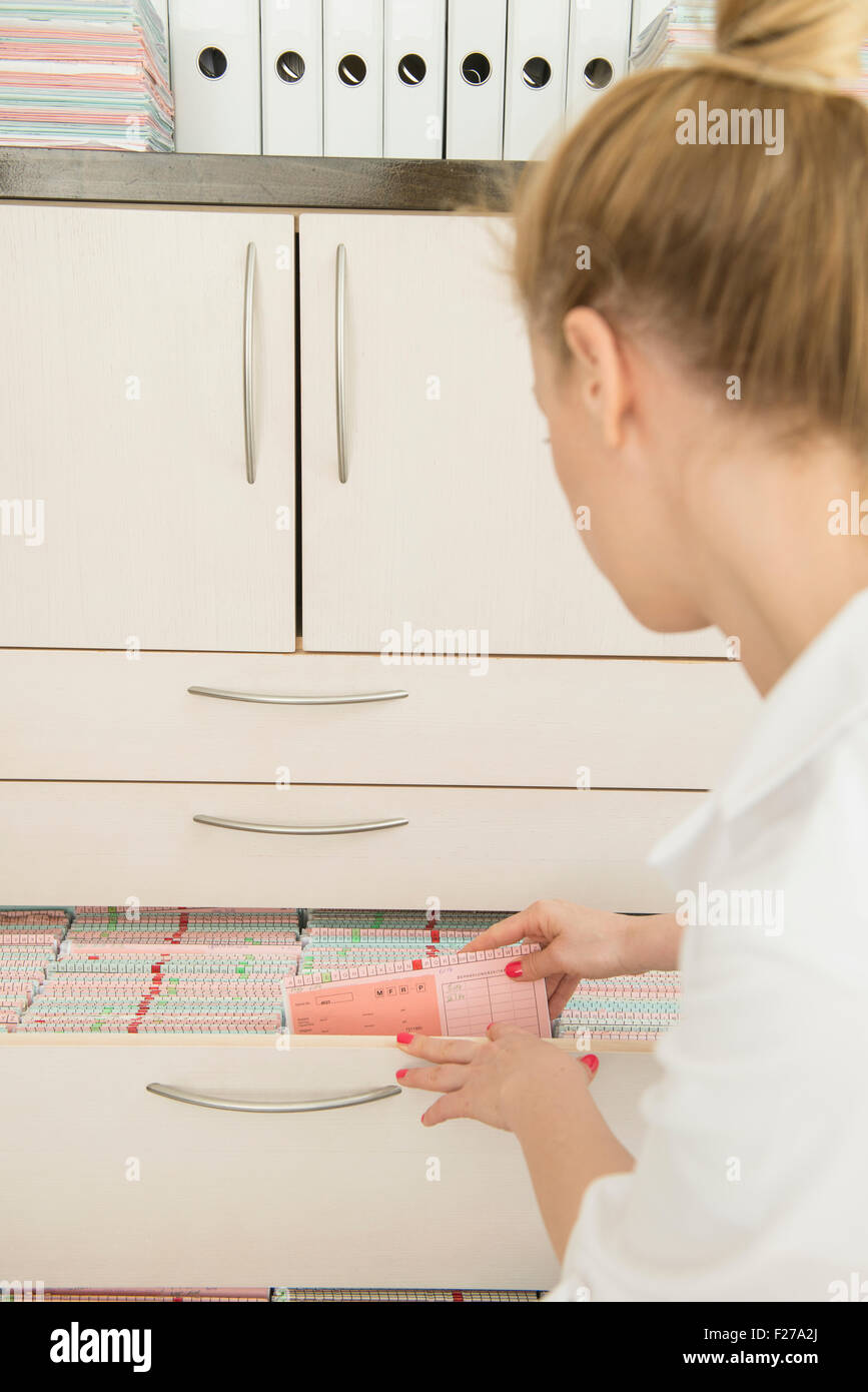 A woman filing documents into a cabinet hi-res stock photography and ...