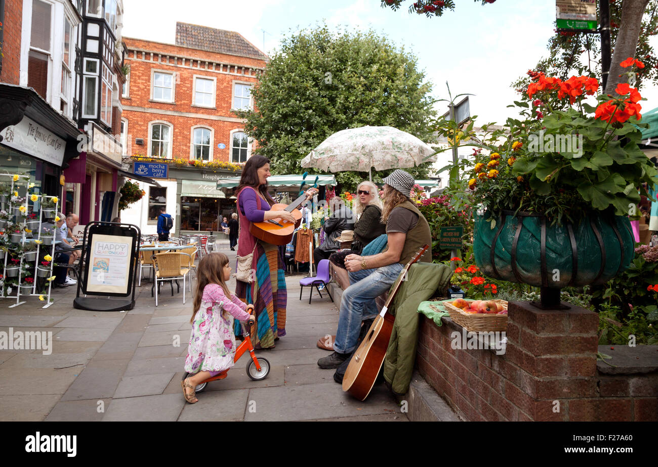 Street scene with local people, the High Street, Glastonbury town ...