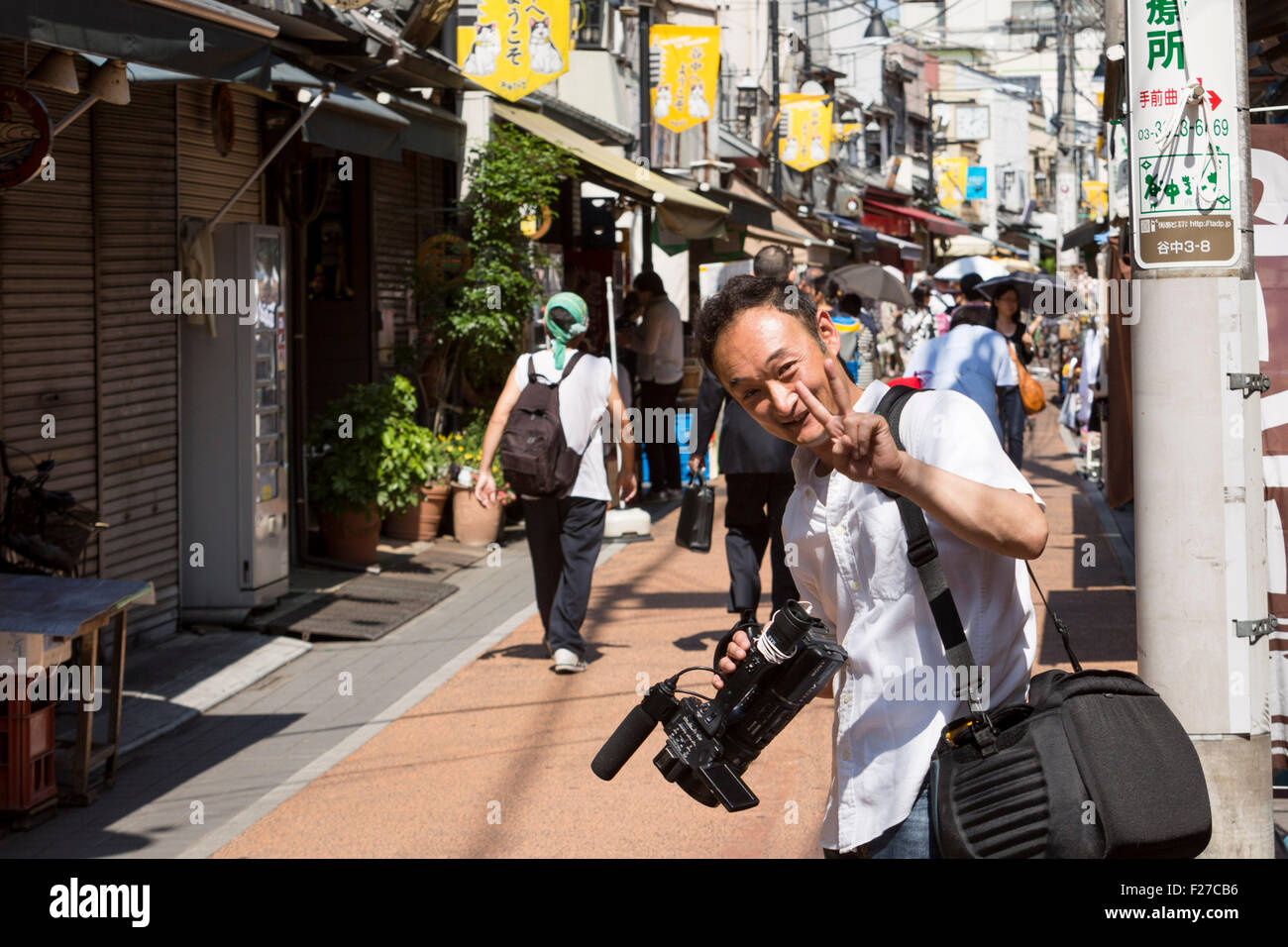 Cameraman smiling for a picture in Yanaka Ginza, Tokyo, Japan Stock ...