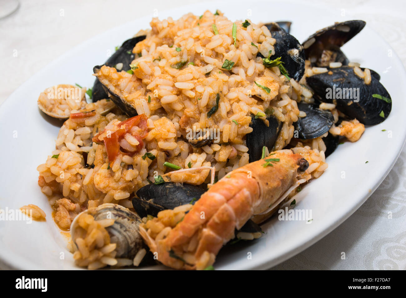 A dish of seafood rice pics, with mussels, clams, shrimp, mussels ...