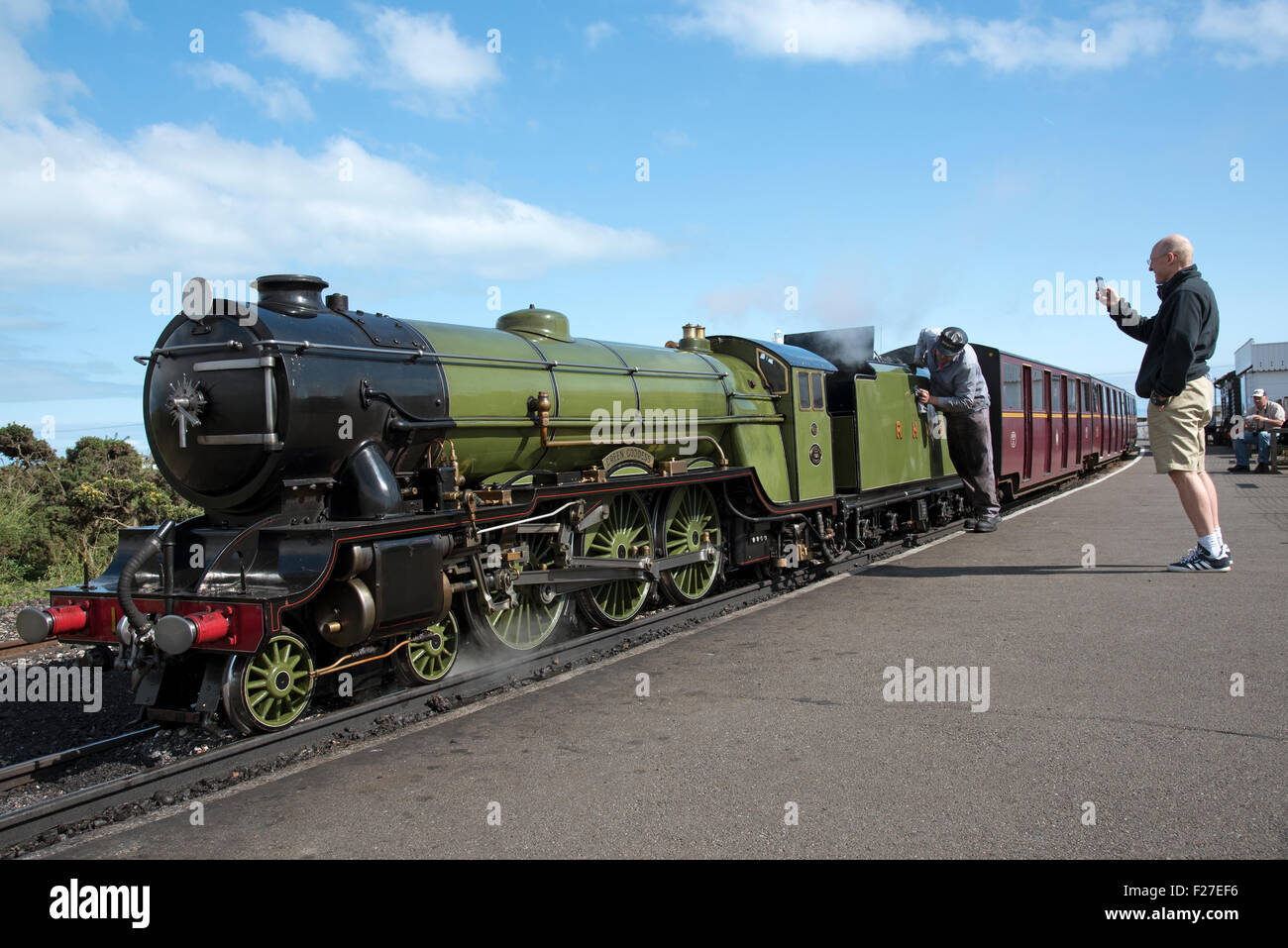 Engine driver polishing the Green Goddess loco which operates a ...