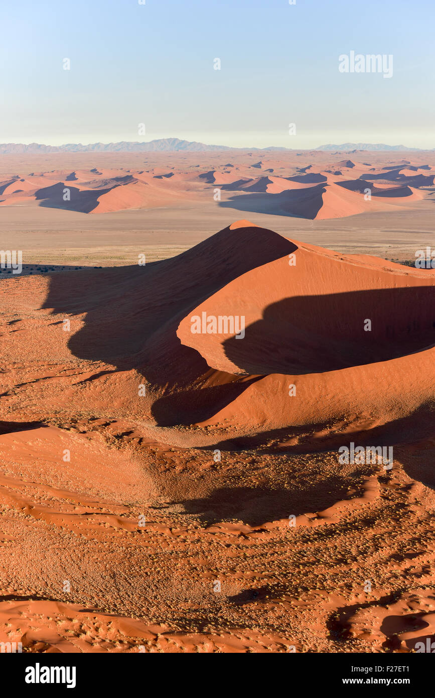 Aerial view of high red dunes, located in the Namib Desert, in the Namib-Naukluft National Park ...