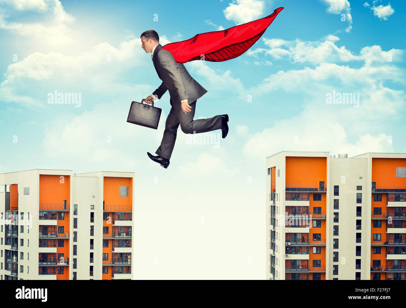 Businessman springing over abyss Stock Photo - Alamy