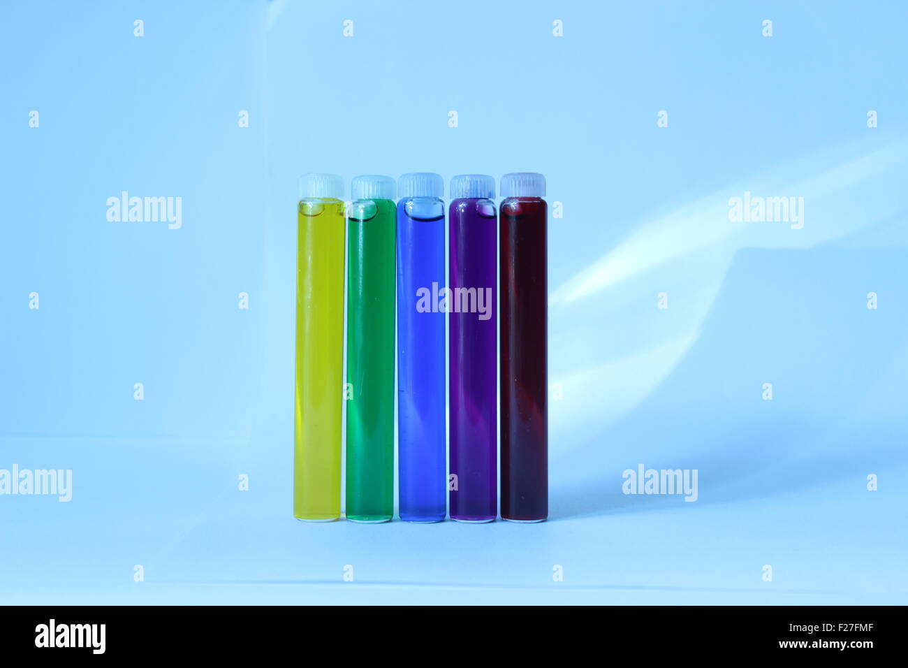 Five vials with a touch of blue Stock Photo - Alamy