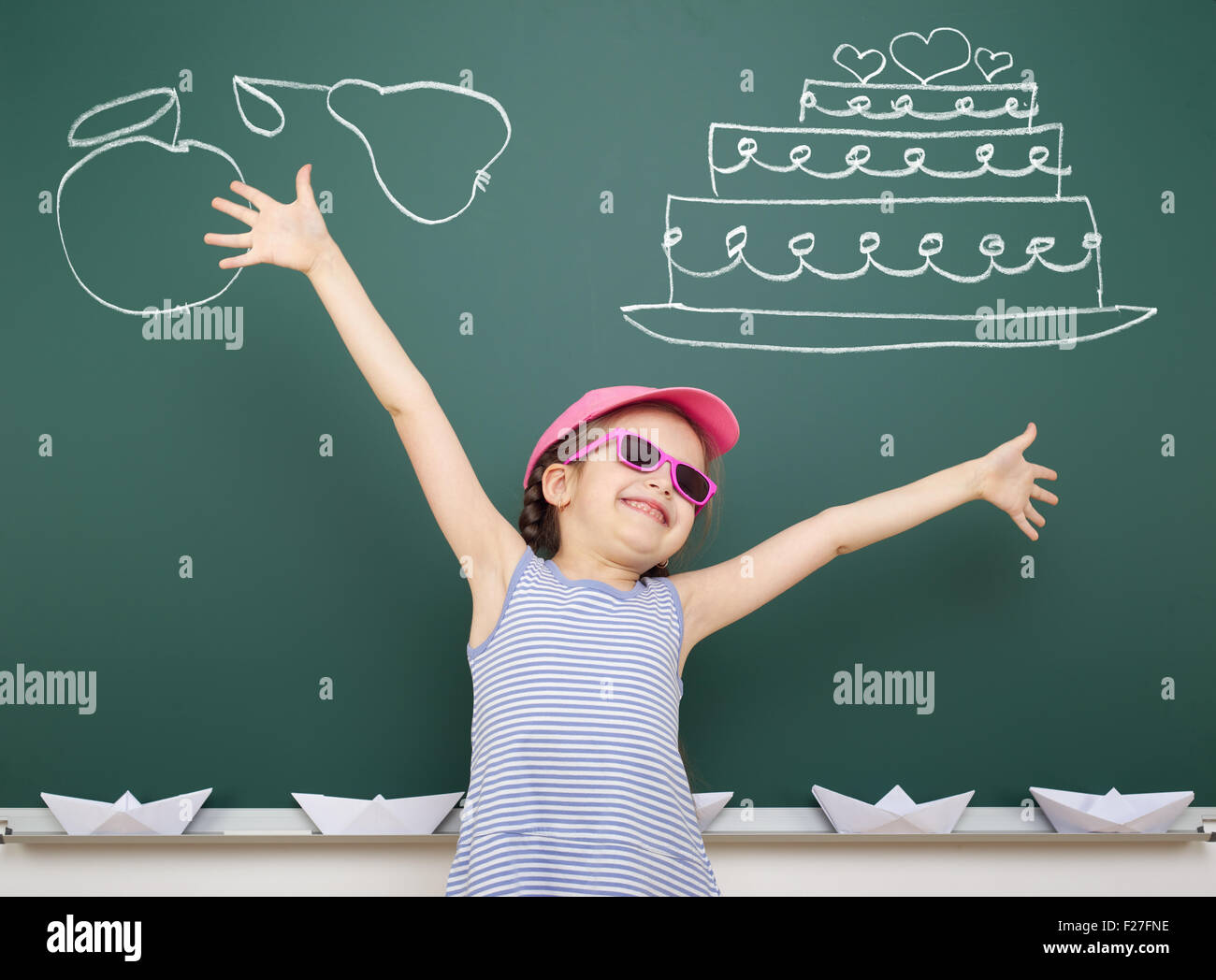 girl drawing cake and fruit on school board Stock Photo - Alamy
