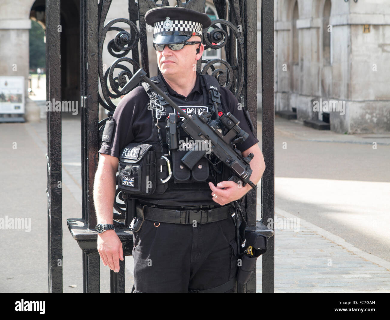A lone policeman armed with a semi automatic machine gun on guard at ...
