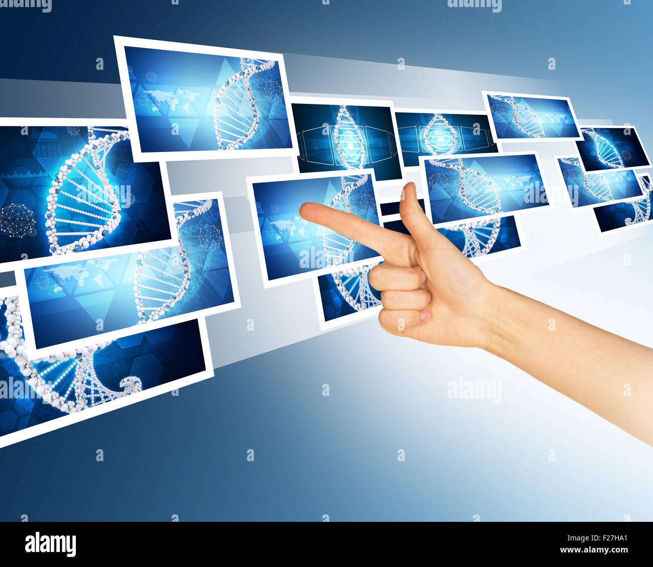 Humans hand pointing blue holographic pictures Stock Photo - Alamy