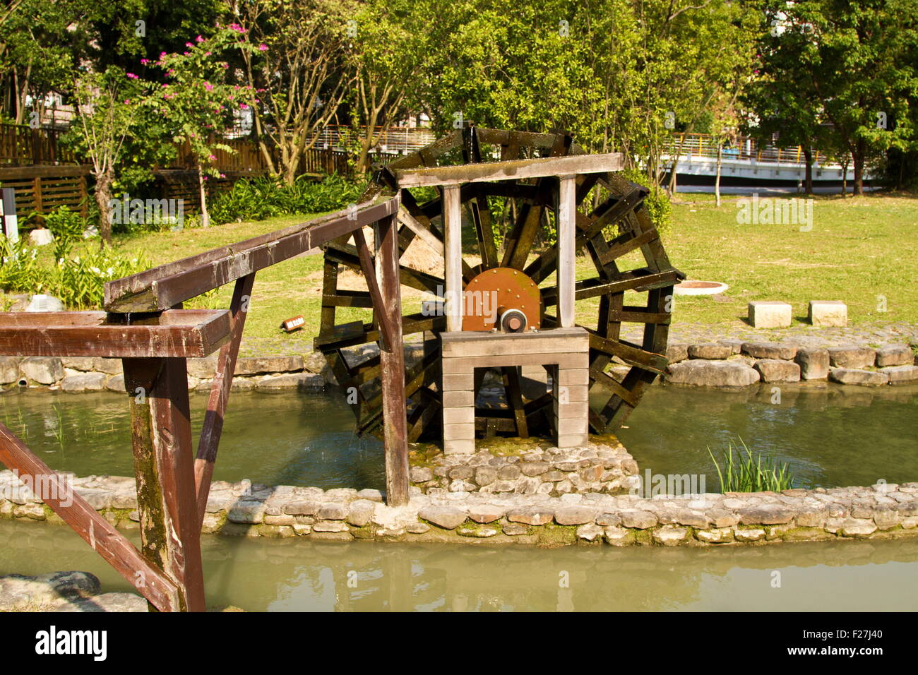 wooden waterwheel in green park Stock Photo - Alamy