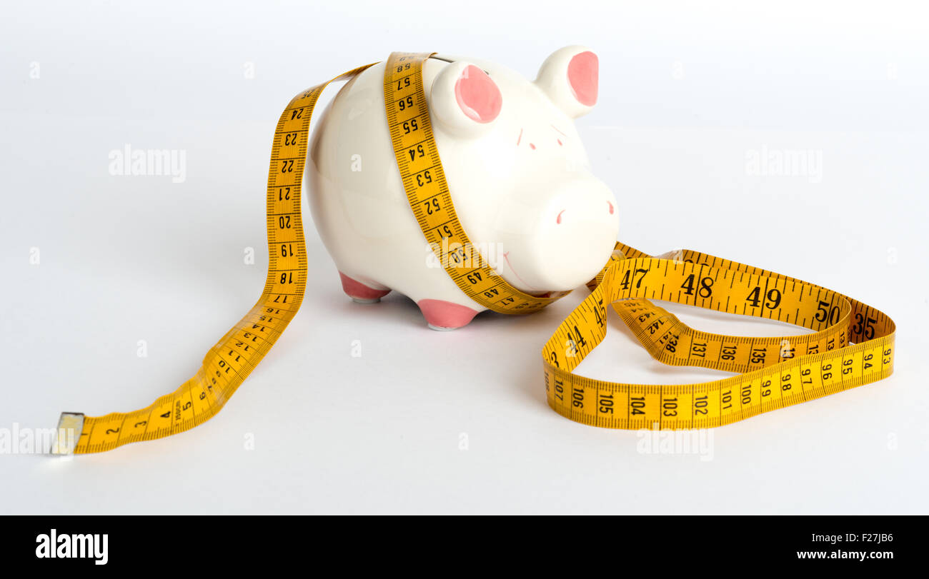 Piggy bank with tape measure, side view Stock Photo - Alamy