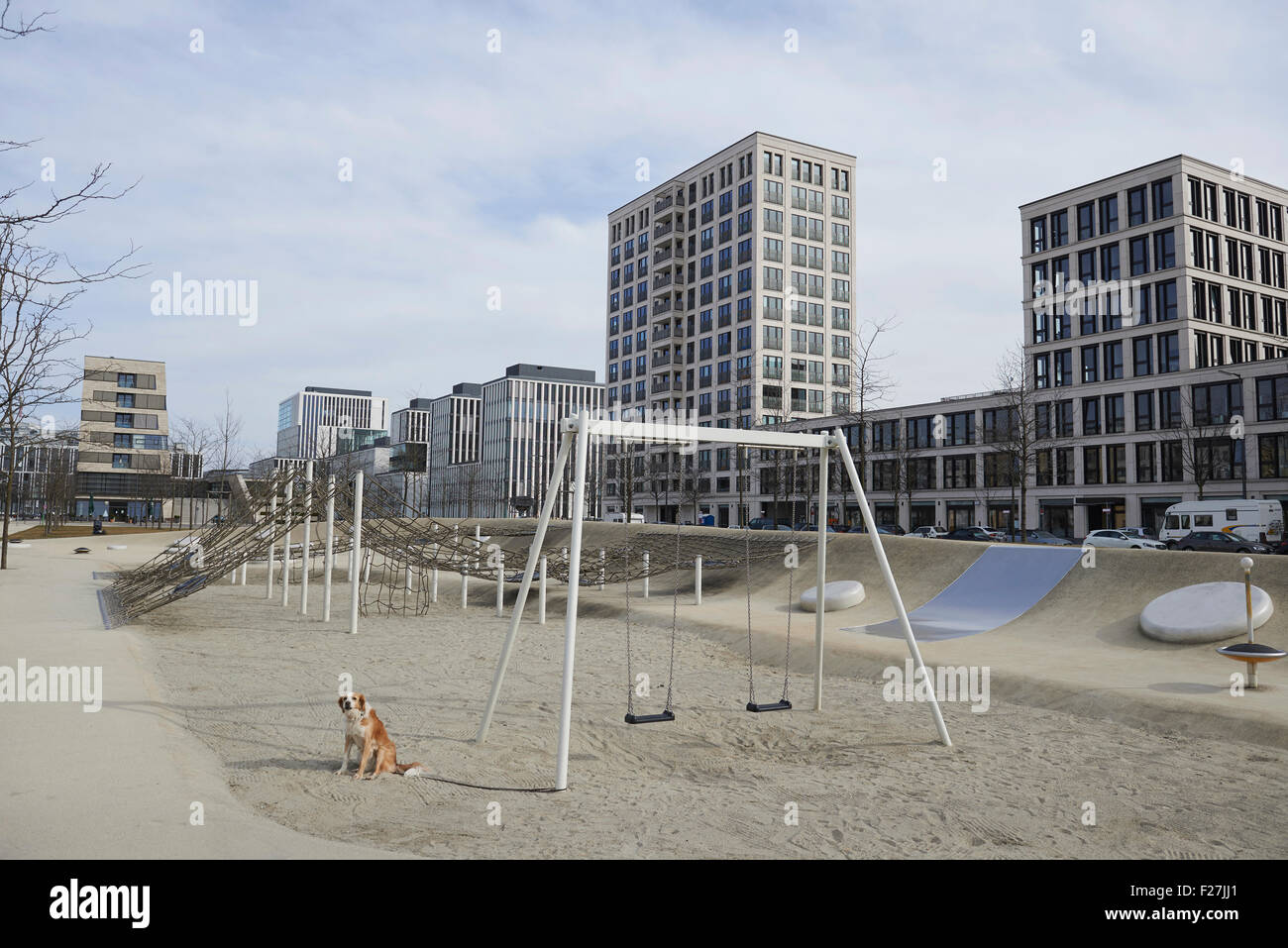 Dog sitting on playground of a city, Munich, Bavaria, Germany Stock ...