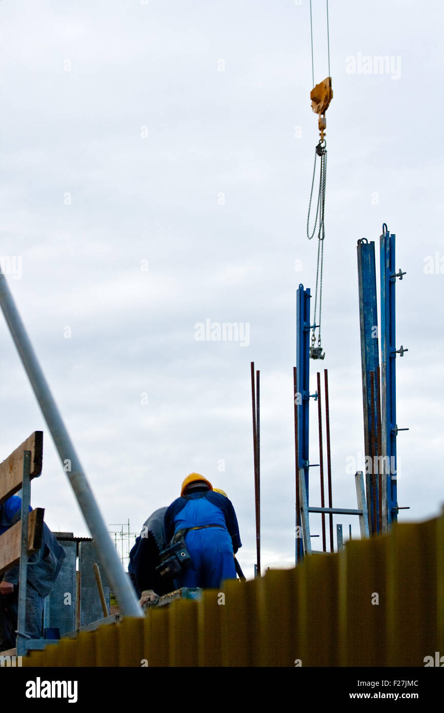 Workers on a construction site Stock Photo - Alamy