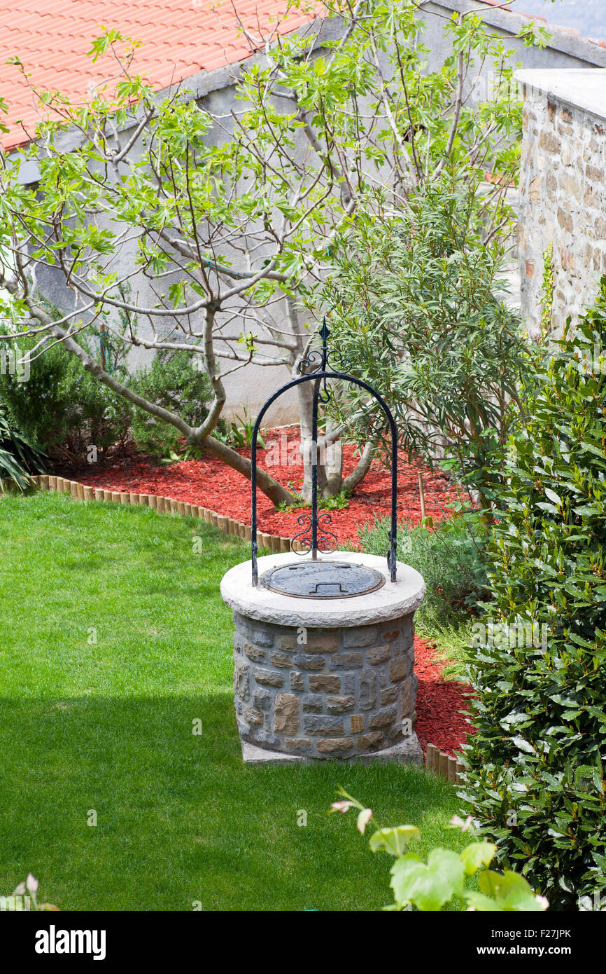 Well in the back of a house with garden Stock Photo - Alamy