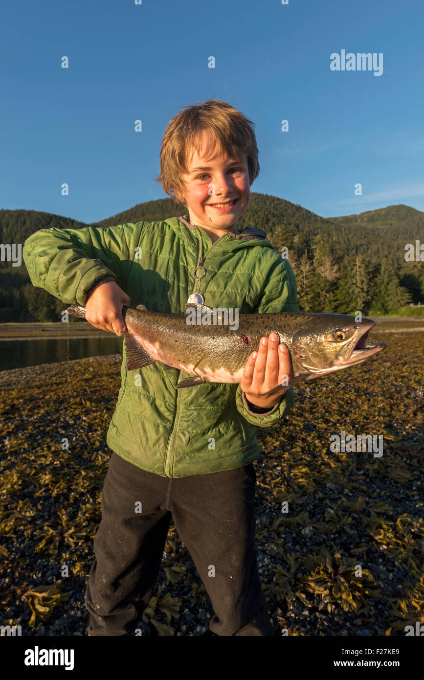Boy with salmon that he caught in Starrigavan Bay, near Sitka, Alaska ...