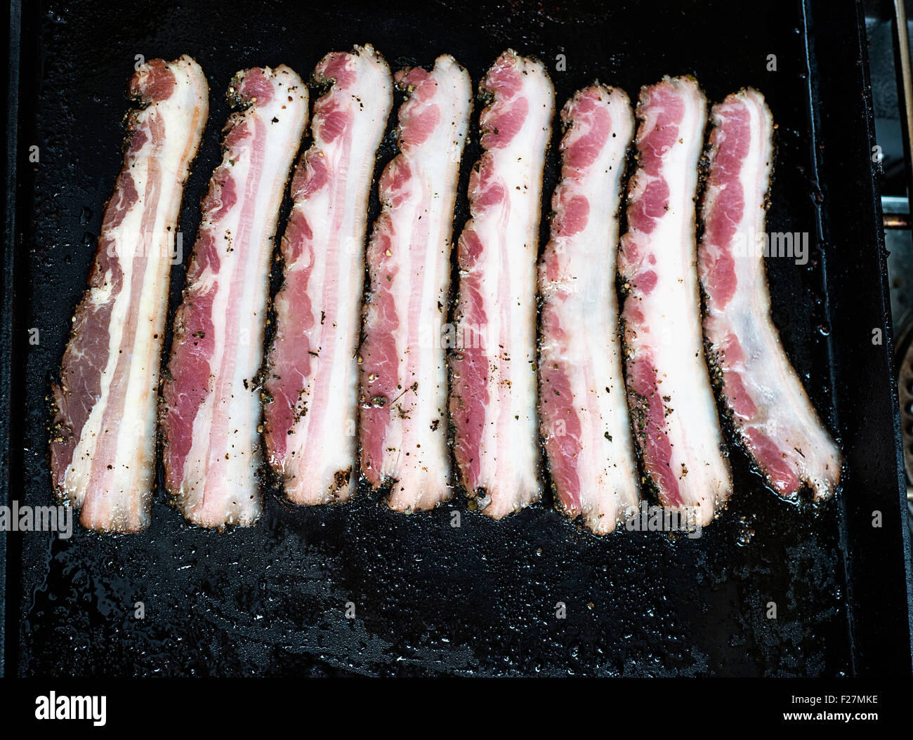 Grilling home made bacon outdoors Stock Photo - Alamy