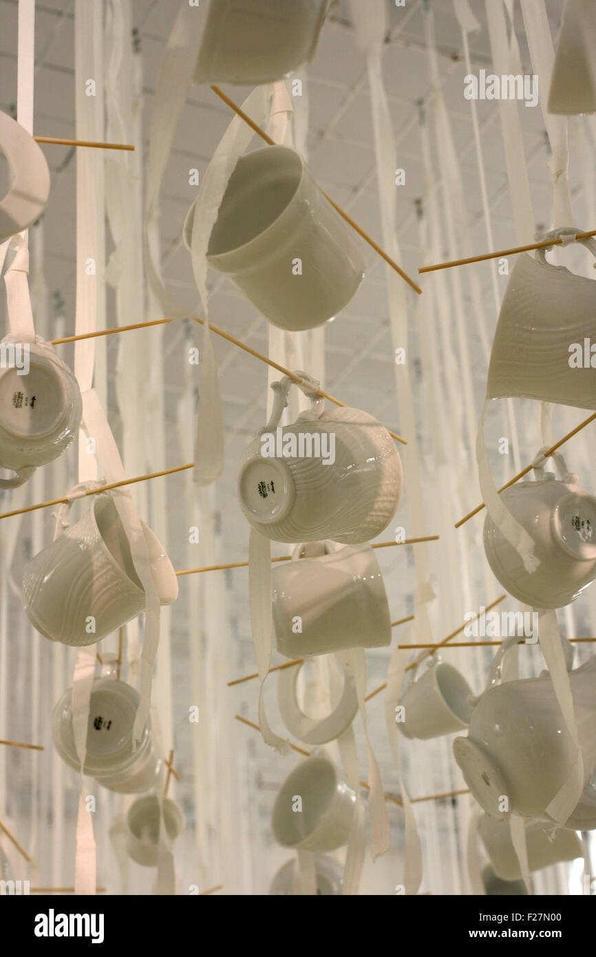 Many white coffee mugs hancing Stock Photo - Alamy