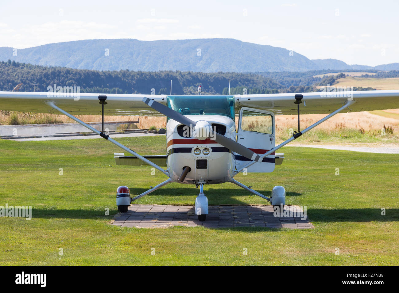 Front of a small passenger plane with propeller and open door on a ...
